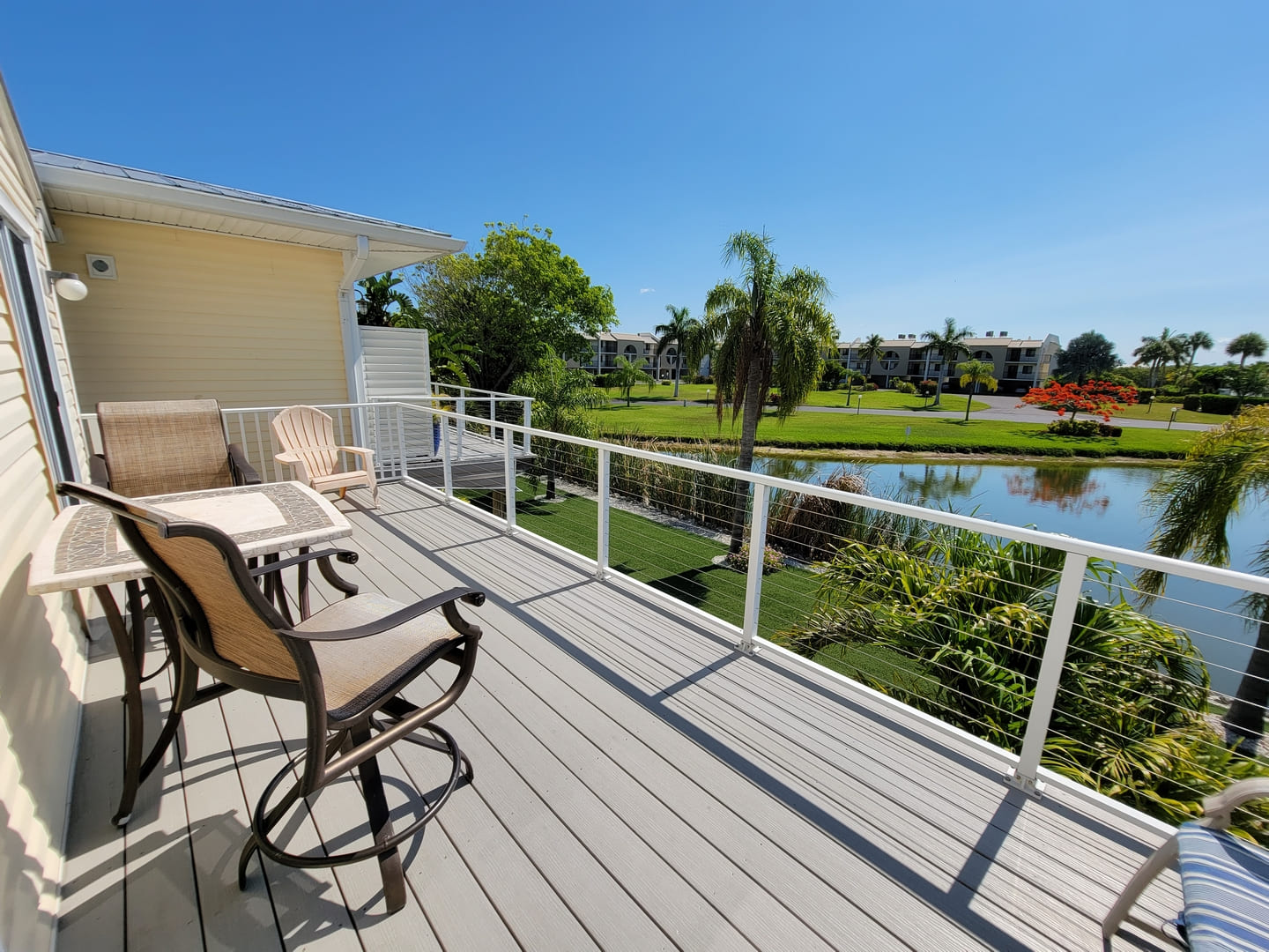 Deck Overlooking Lake And Shared Tiki Bar Area - Charming Lakeside Oasis - Fort Myers Beach, FL